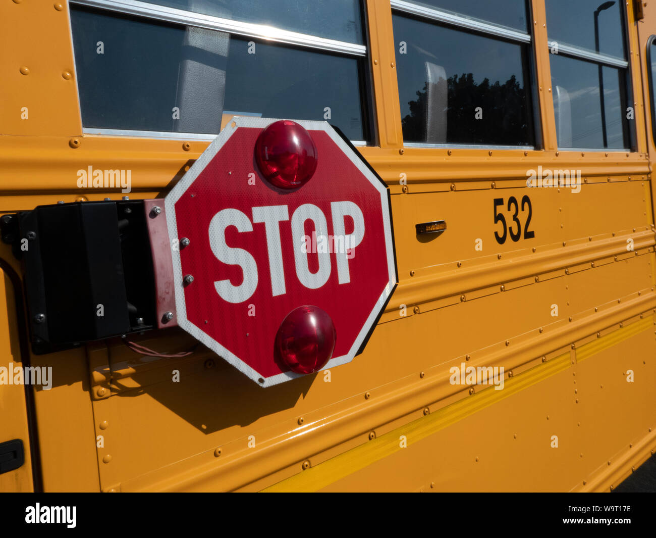 School buses parked on lot Stock Photo - Alamy
