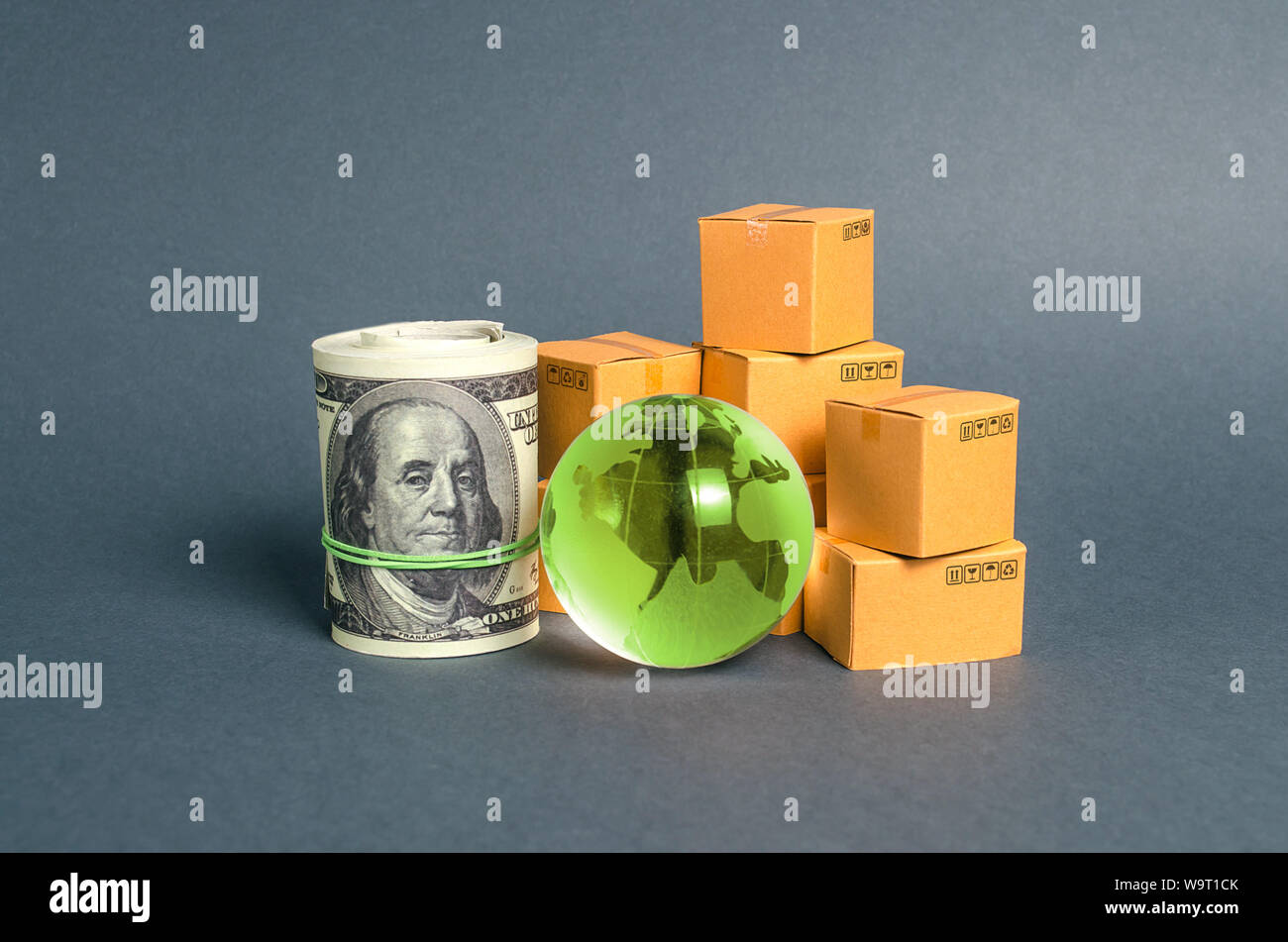 Green planet earth globe, bundle of money and cardboard boxes. Business ...