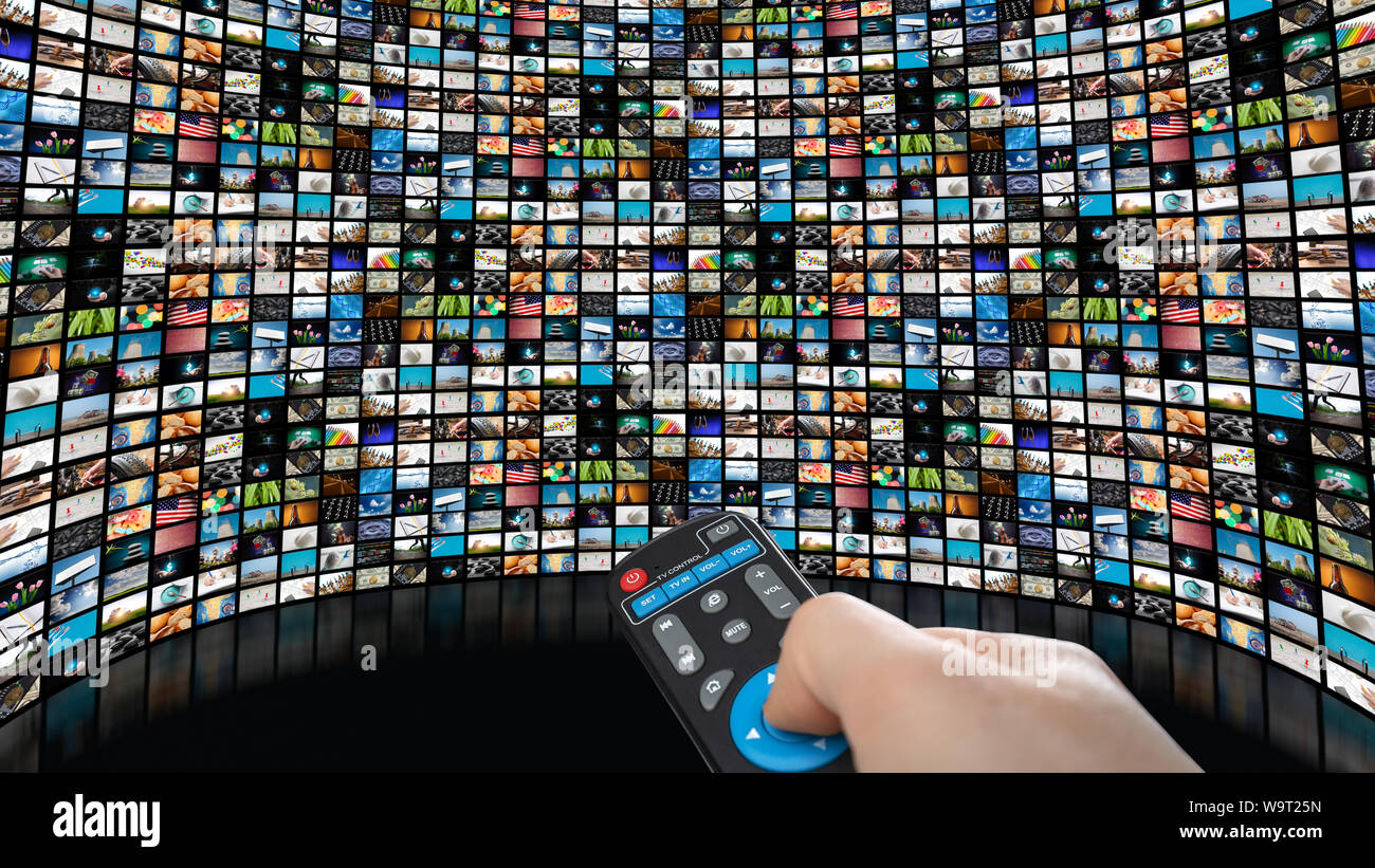 Image of large screen with many channels, hands of man with remote ...