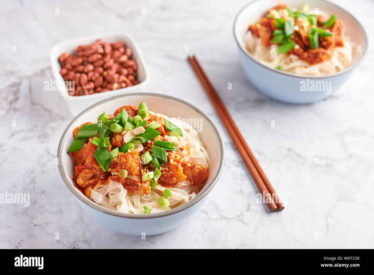 shan noodles with peanuts and chopsticks at white marble tabletop ...