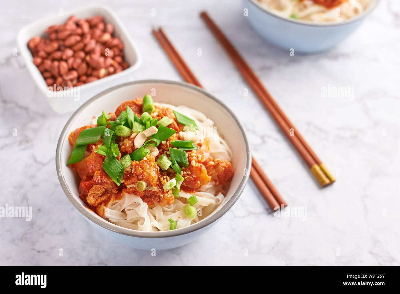 shan noodles with peanuts and chopsticks at white marble tabletop ...
