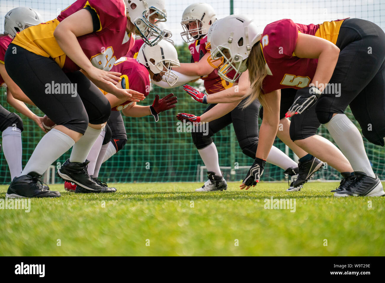 Photo of athletes women wearing helmets playing american football on ...