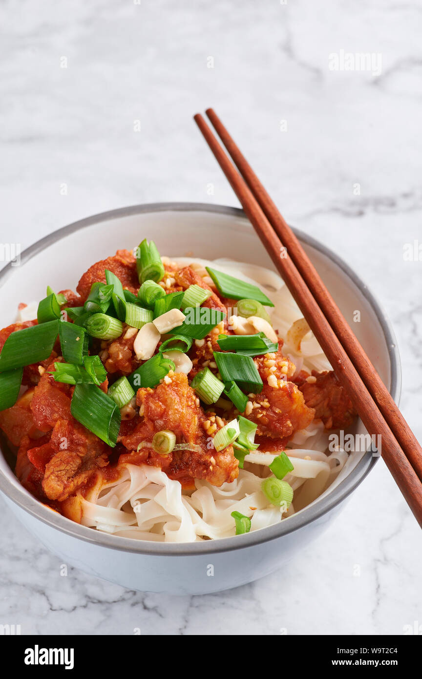 shan noodles with chopsticks at white marble tabletop. burmese cuisine ...