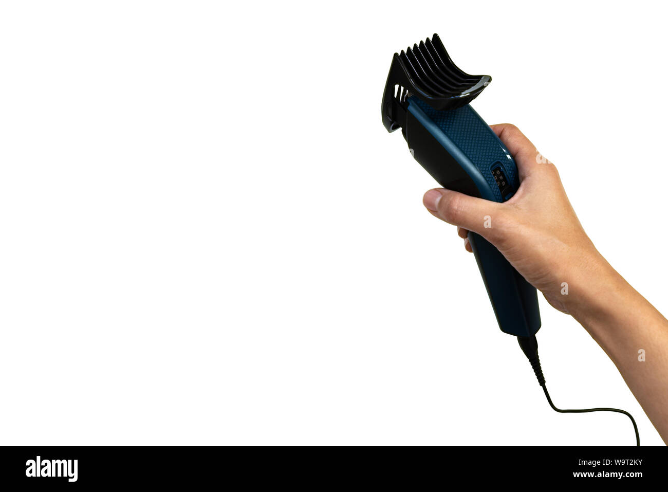 Hand holding electric hair trimmer isolated on white background. Copy ...