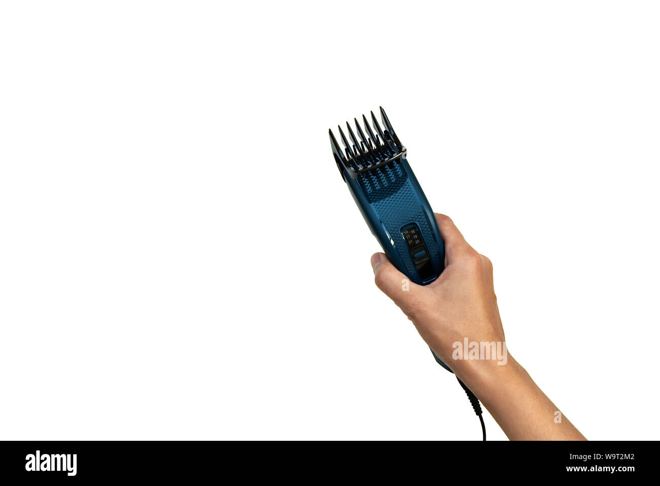 Hand holding electric hair trimmer isolated on white background. Copy ...