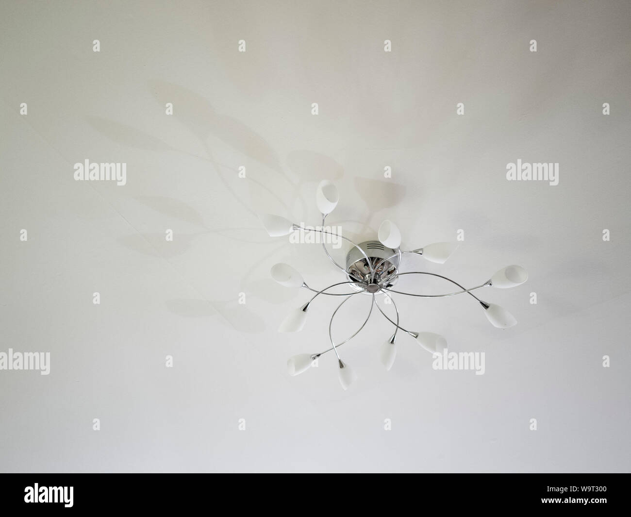 A domestic ornamental halogen light fitting on a ceiling Stock Photo ...
