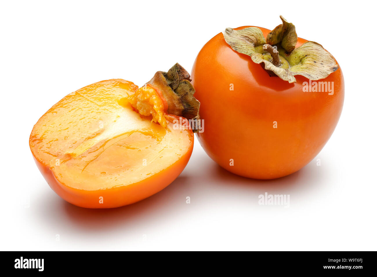 Whole and sliced ripe persimmon fruits isolated on white background ...