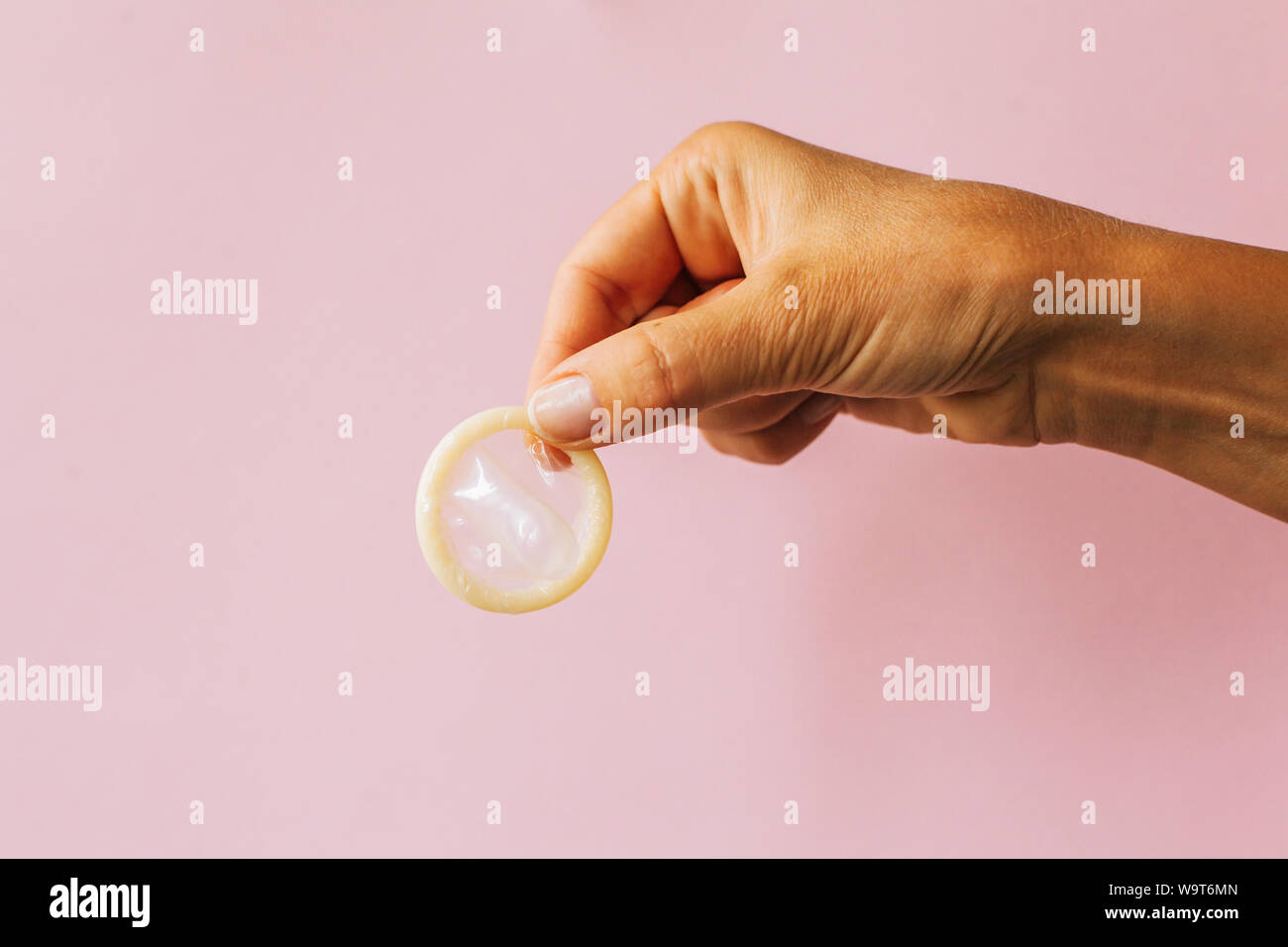 Woman holding condom hi-res stock photography and images - Alamy