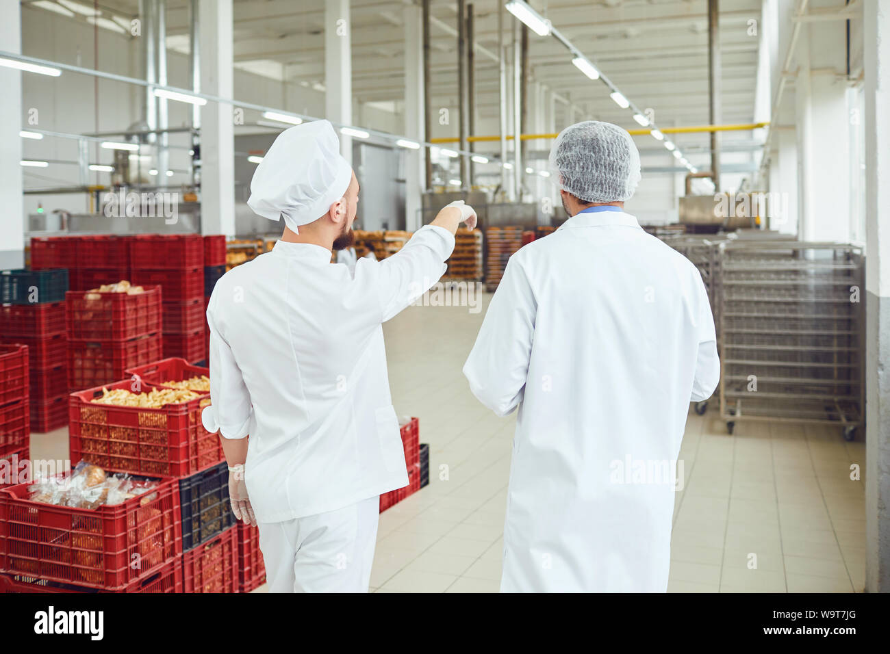 The technologist and baker speak in a bread factory Stock Photo - Alamy