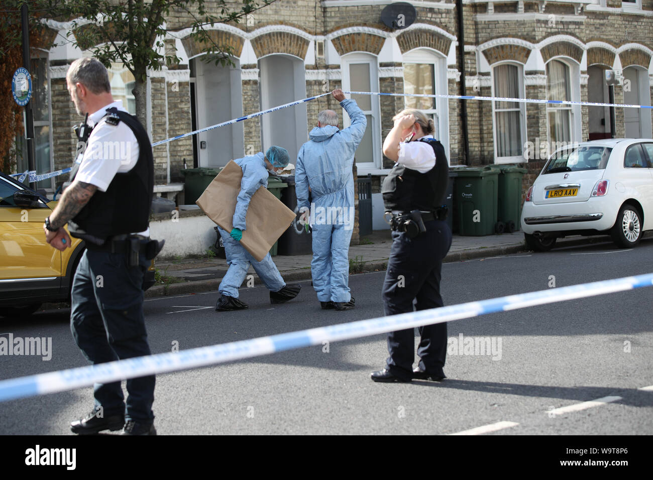 Forensic and police officers at the scene of a fatal stabbing in ...