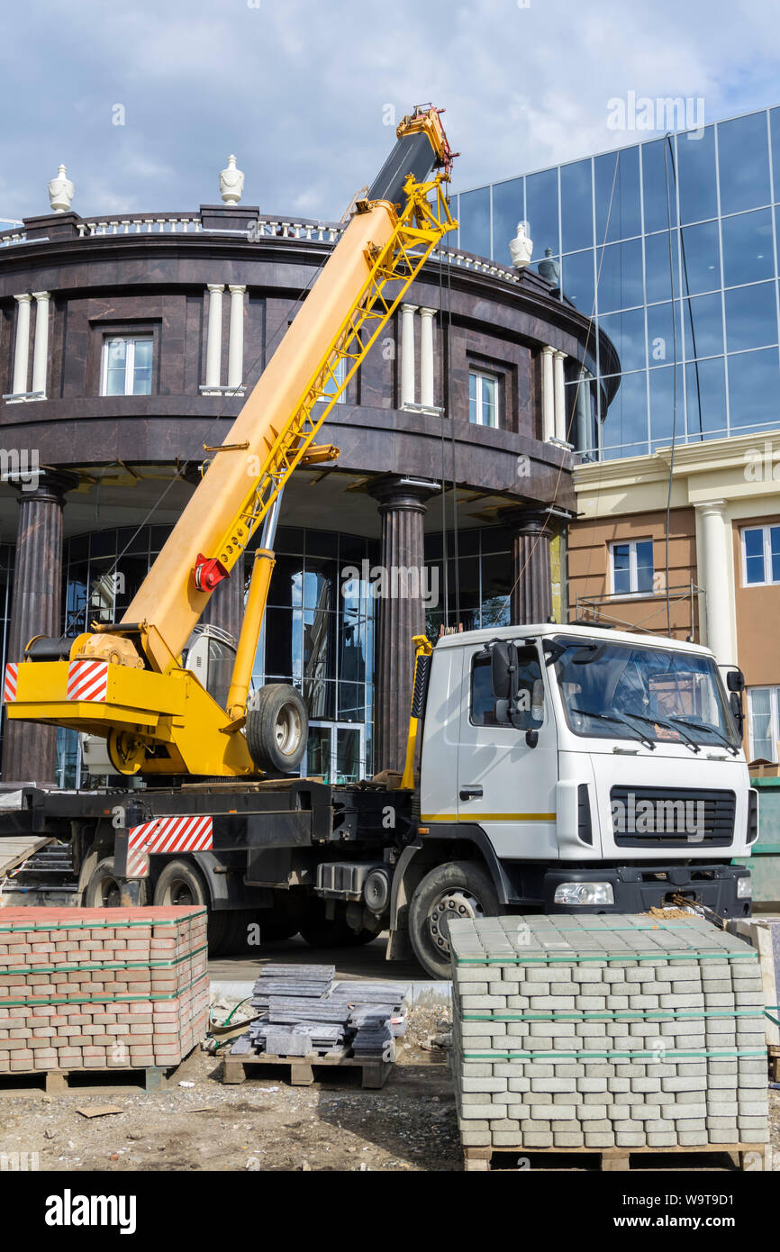 Truck-mounted crane on a building construction site Stock Photo - Alamy