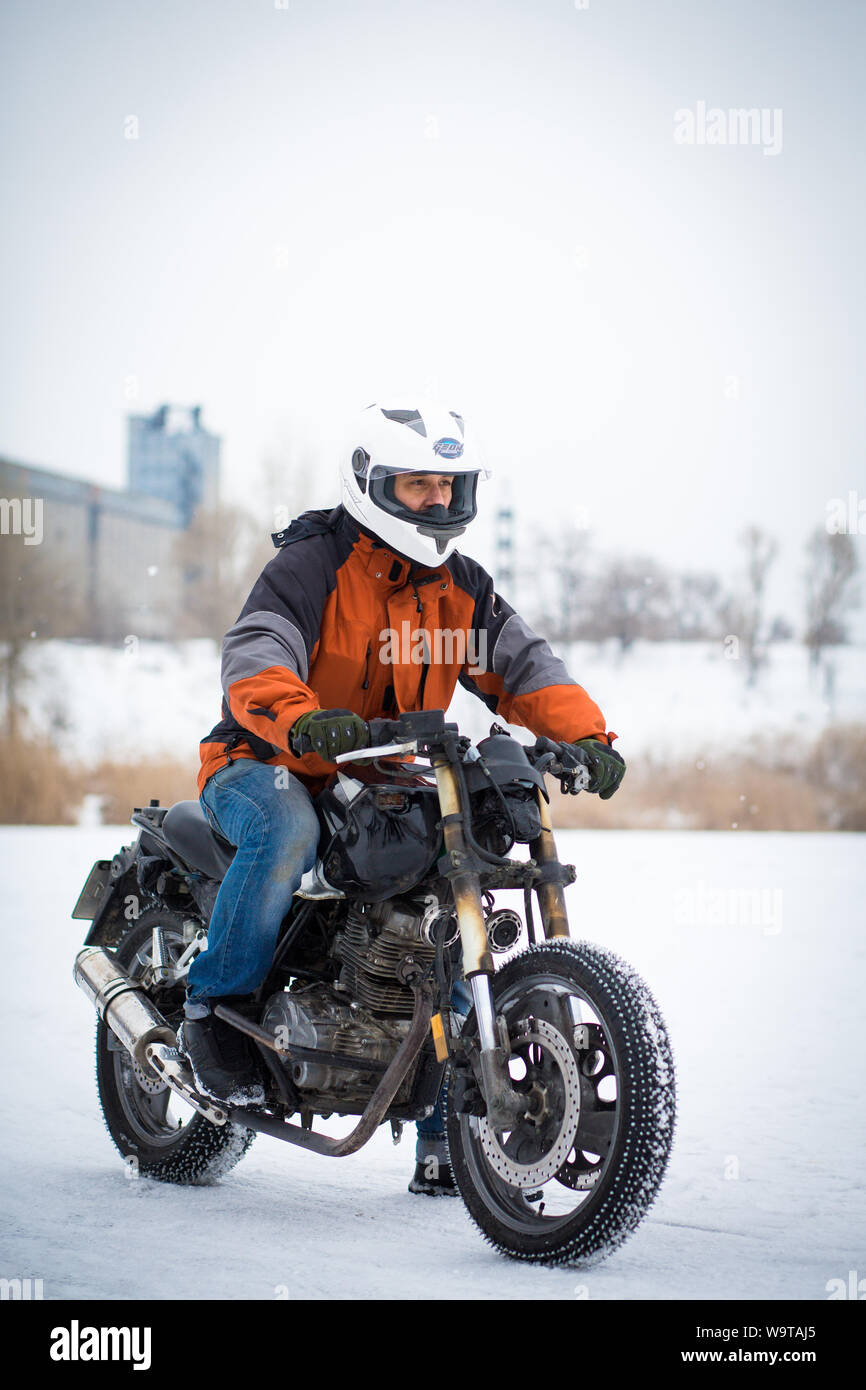 A guy rides a motorcycle on a frozen lake Stock Photo - Alamy