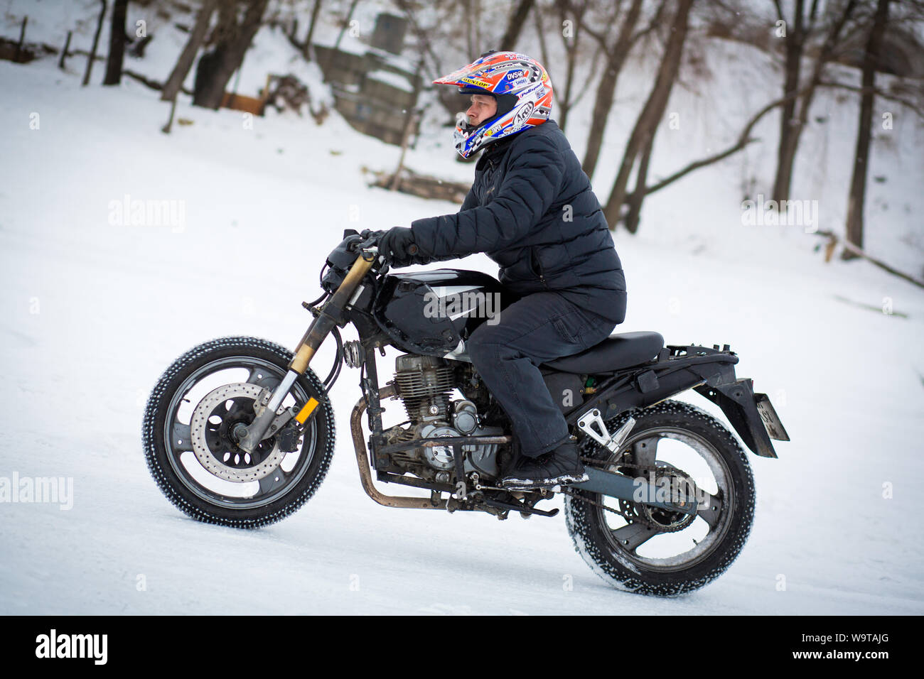 A guy rides a motorcycle on a frozen lake Stock Photo - Alamy