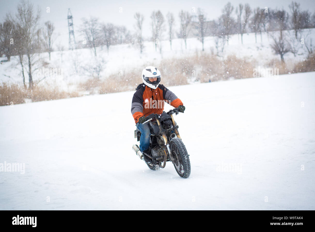 A guy rides a motorcycle on a frozen lake Stock Photo - Alamy