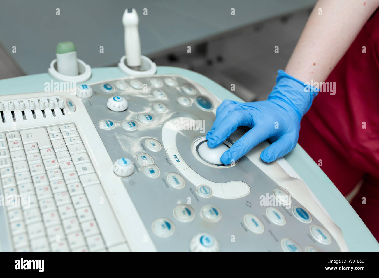 Female doctor's hand on ultrasound machine close up Stock Photo - Alamy