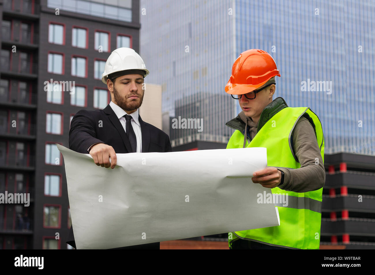 engineer and builder explaining drawing architect plan professional ...