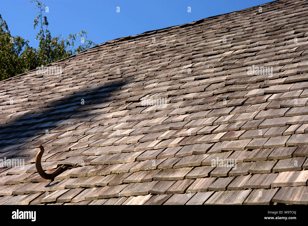 roof with wood shingles, wood shingles on a roof top of an old hut in ...