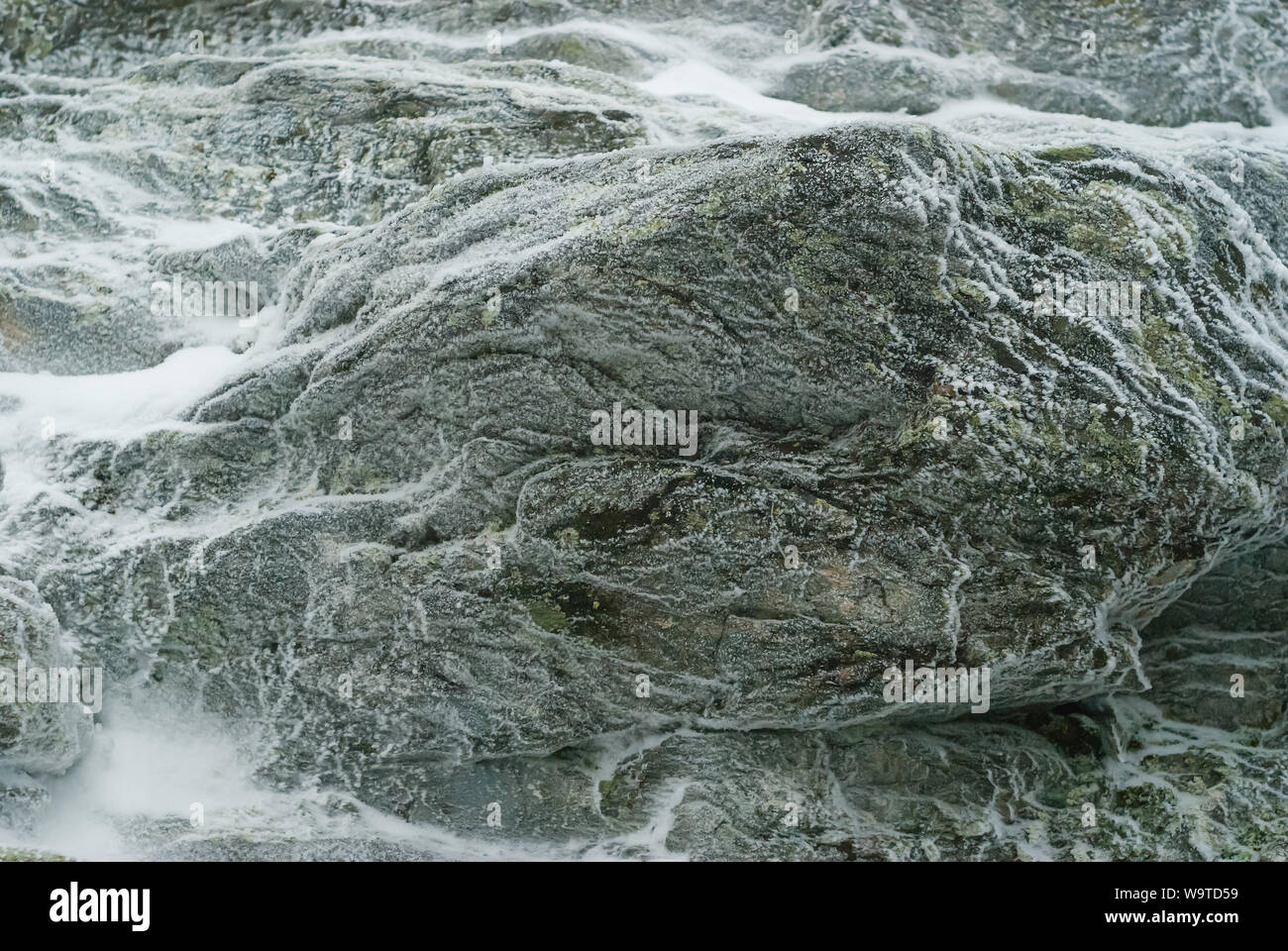background, texture - bizarrely wrinkled surface of natural old rock ...