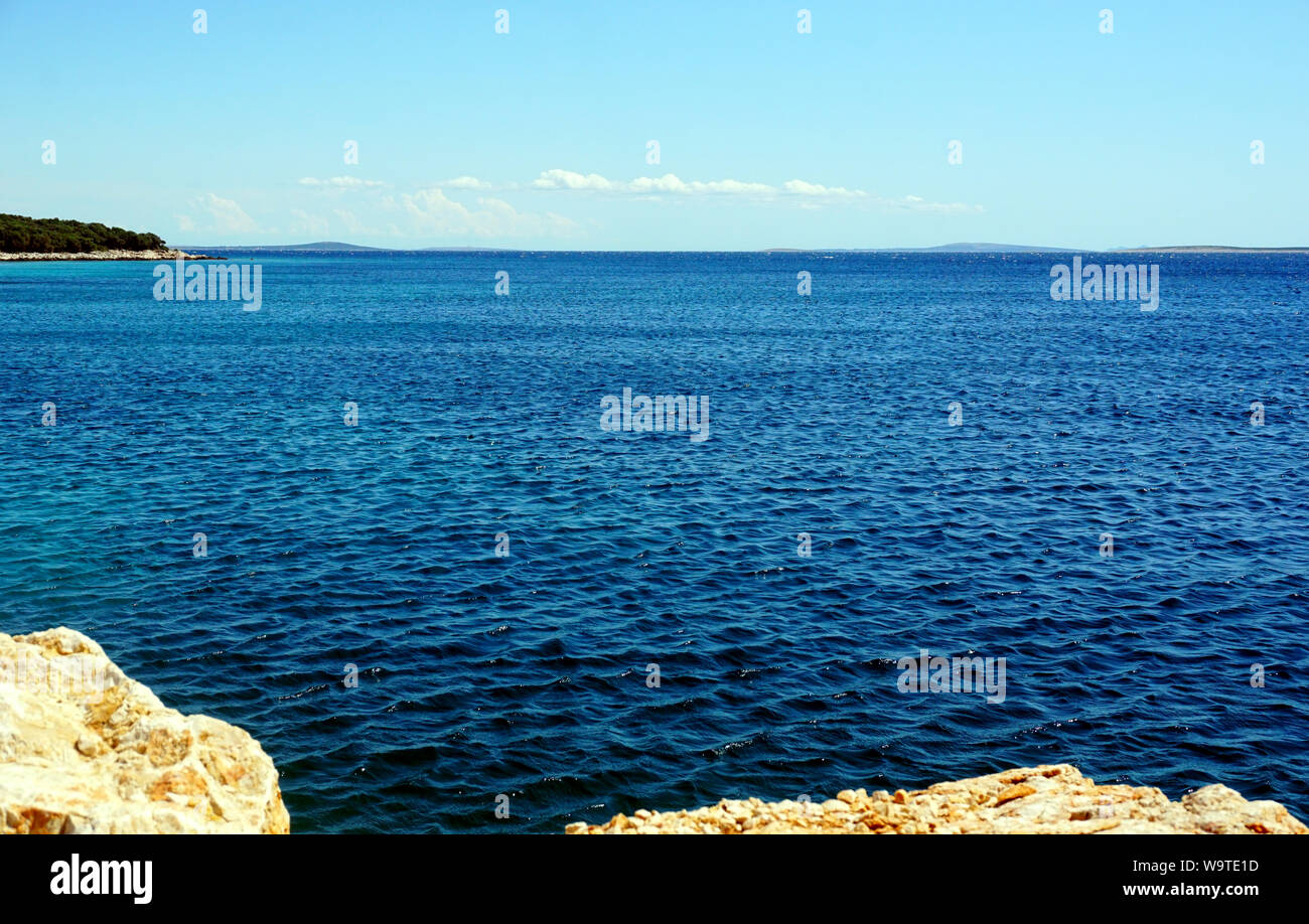 Nature background with blue wavy sea surface and horizon line, view ...