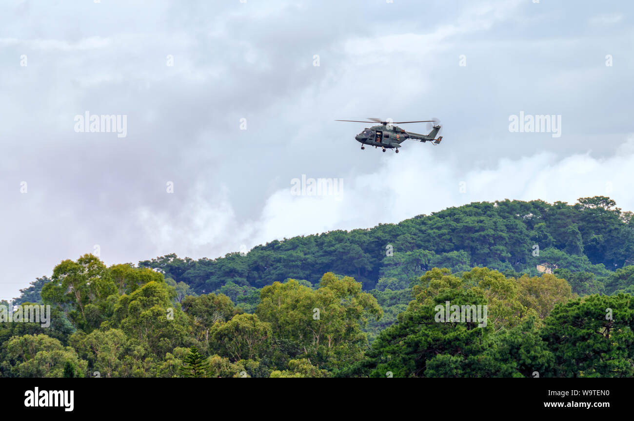 An Indian Air Force Dhruv helicopter flies with its door open as it ...