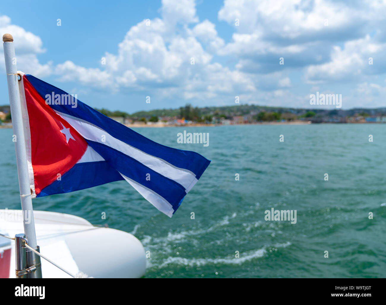 Cuba flag waving on boat at sea near Cuban coastline. Tourism in Cuba ...