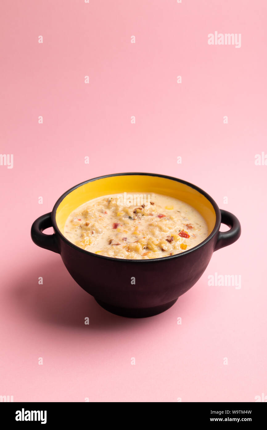 Chowder with Sweet Corn, Shrimp and Bacon in black bowl on pink ...