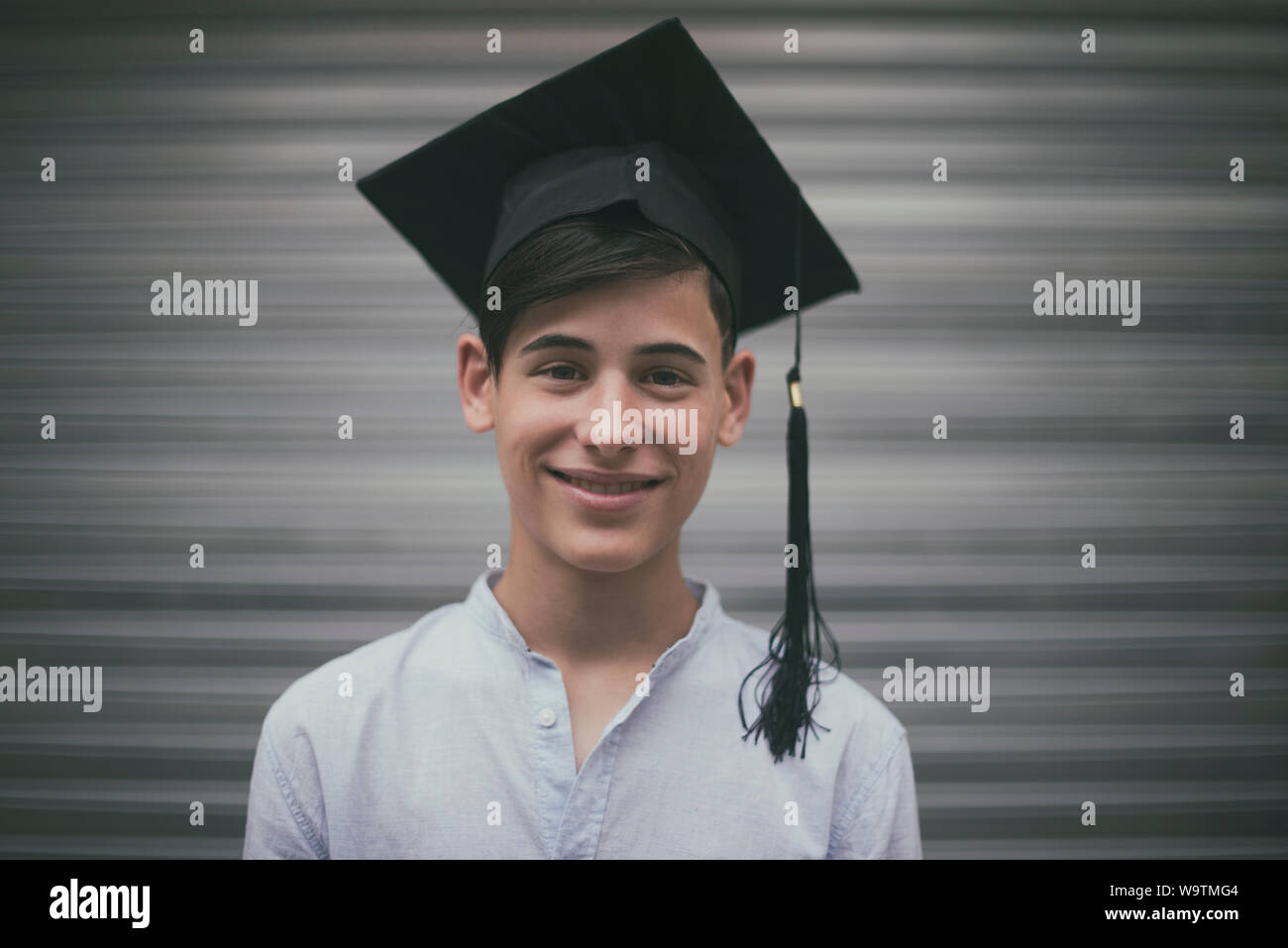 Portrait of a smiling teenage boy at graduation, Spain Stock Photo - Alamy