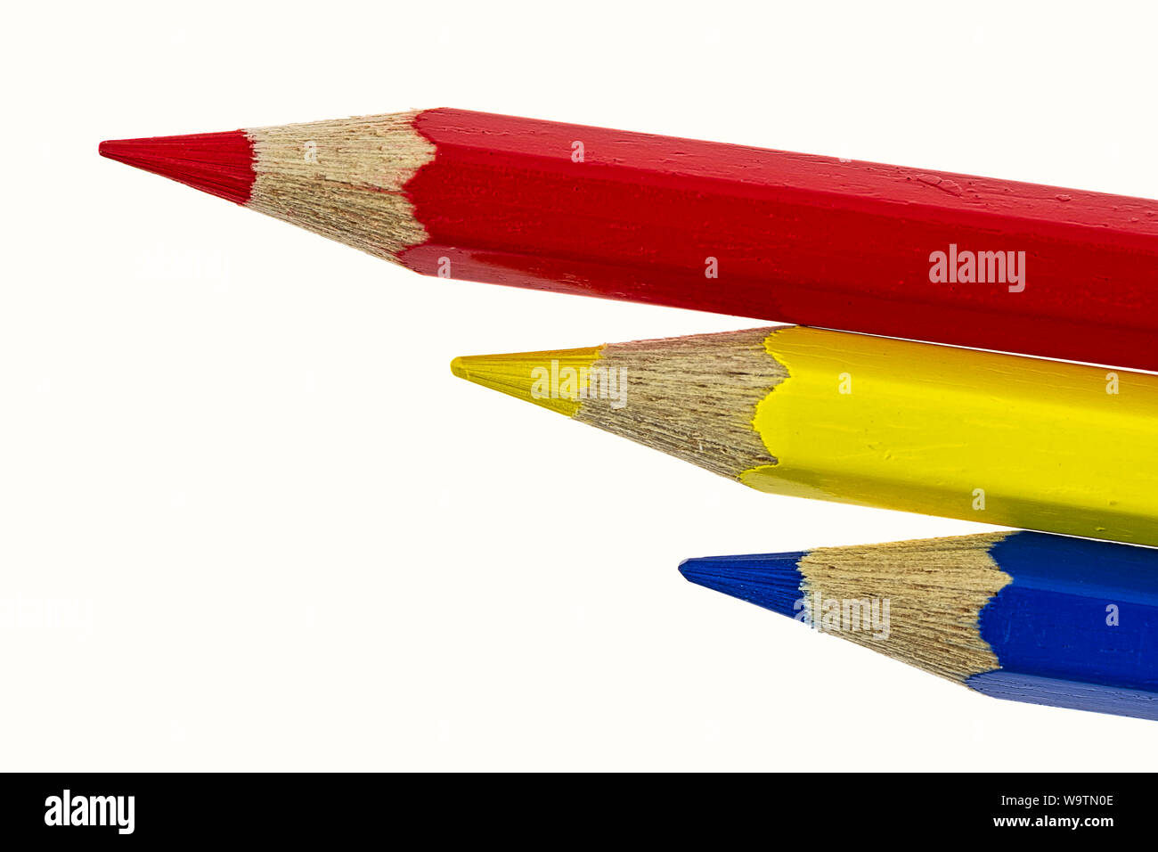 red, yellow and blue colored pencils on white background Stock Photo ...