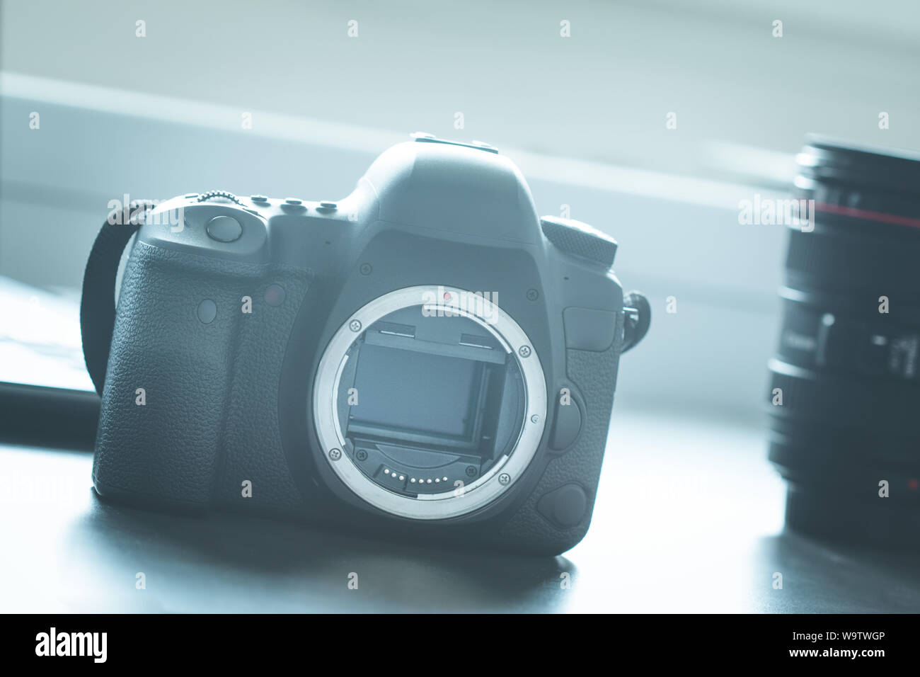 Professional reflex camera on a table, camera sensor. Lenses in the ...