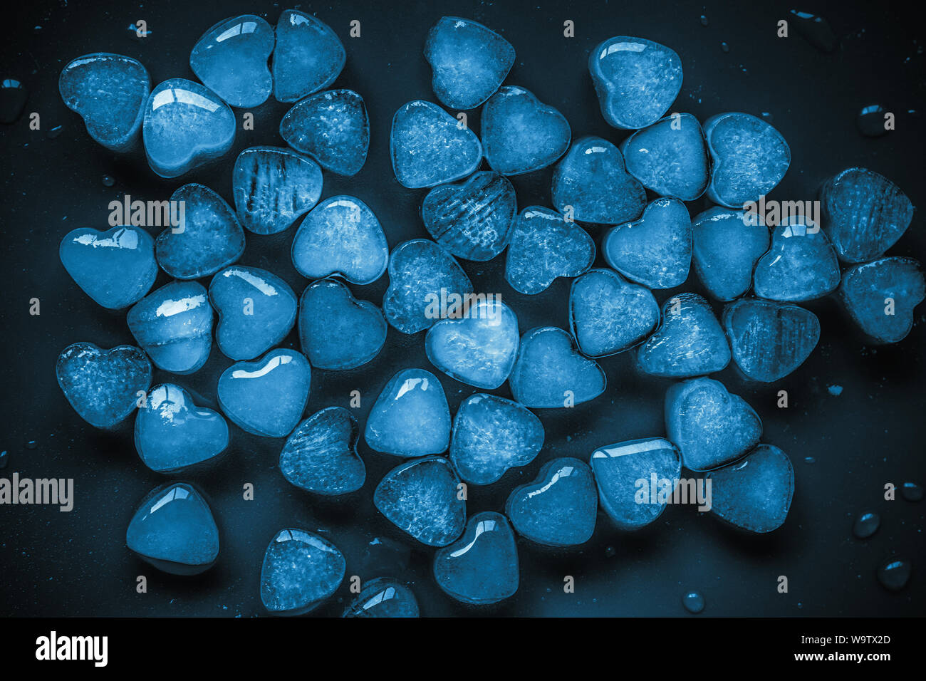 Blue frozen hearts on dark background. Cold heart of ice on romantic ...