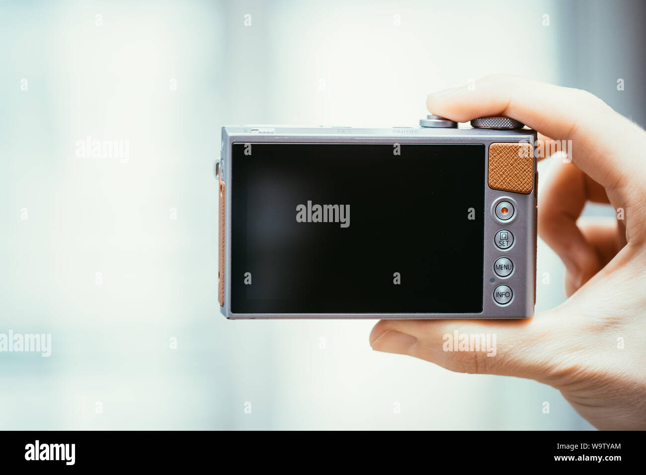 Reverse side of a digital camera, black lcd screen and some keys ...