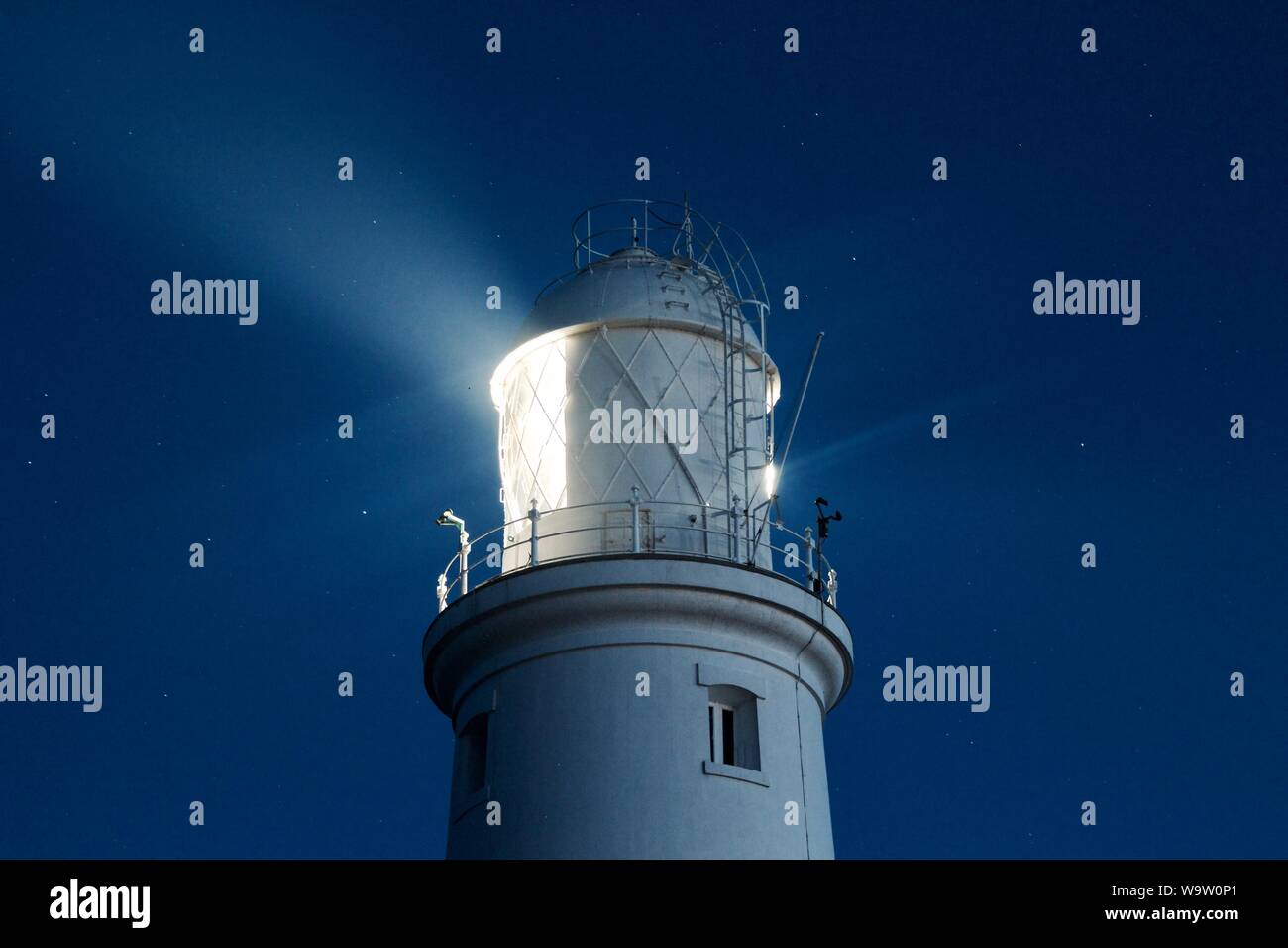 Illuminated lighthouse during nighttime Stock Photo - Alamy