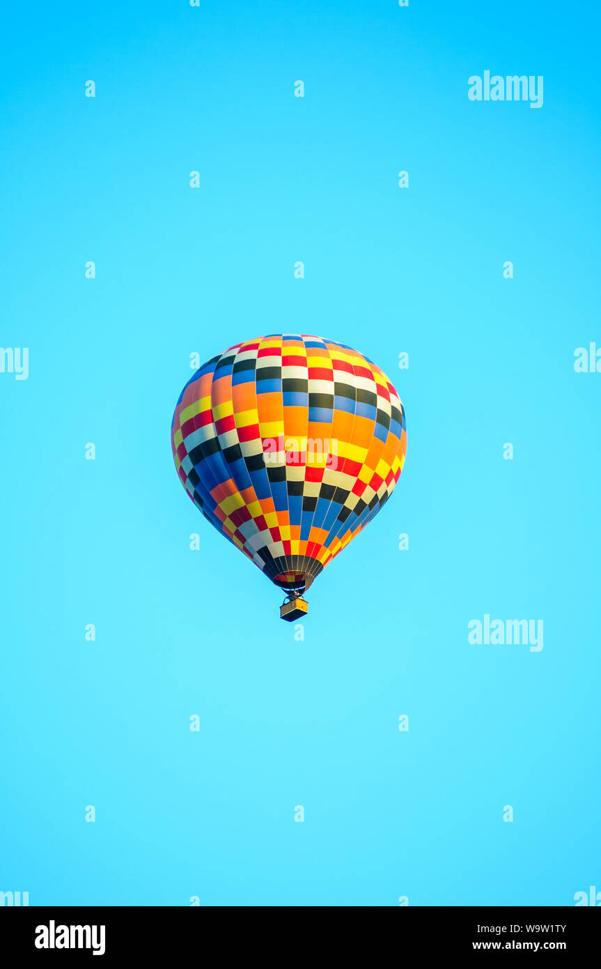 Colorful hot air balloon taking off with blue sky Stock Photo - Alamy