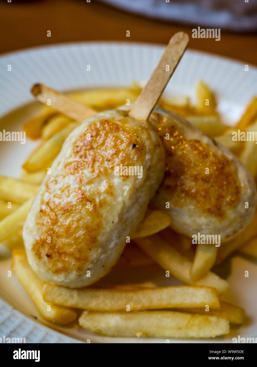 child menu - french fries and chicken popsicle cutlets on white plate ...