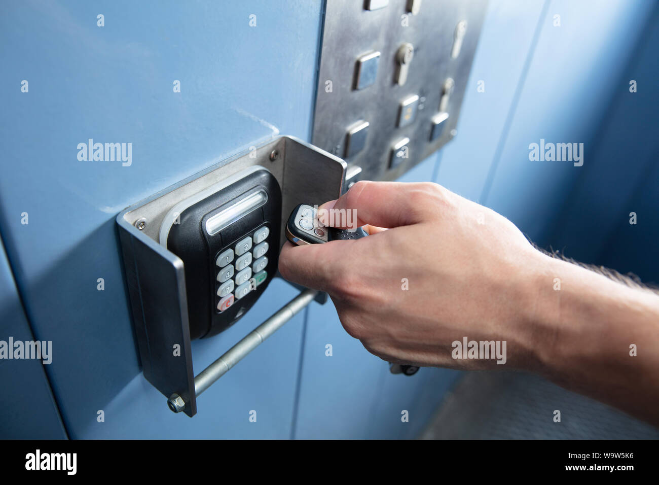 Close-up Of Man's Hand Pressing Remote Control In Elevator Stock Photo ...