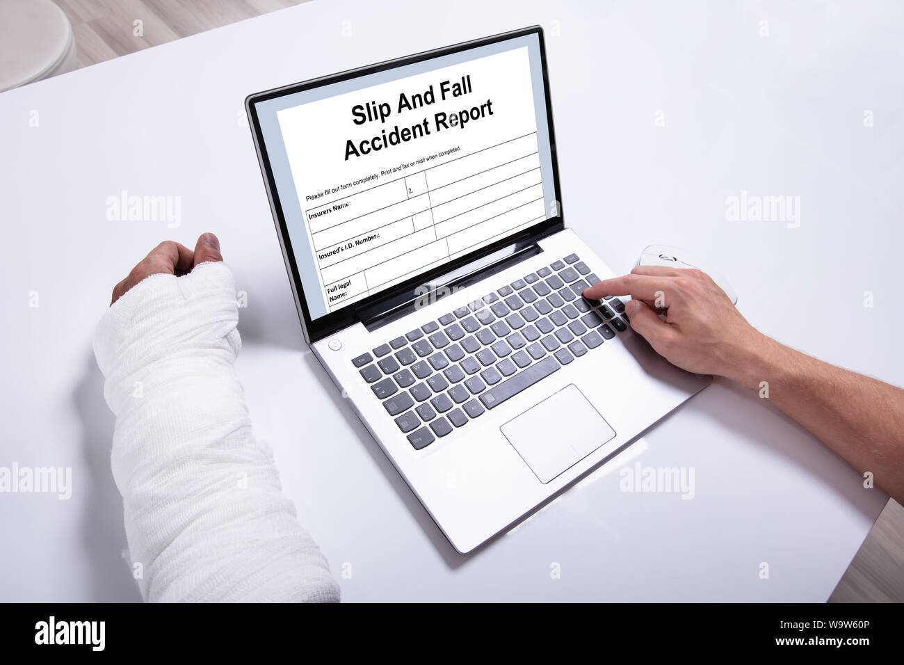 Close-up Of A Person's Hand Filling Health Insurance Claim Form Over ...