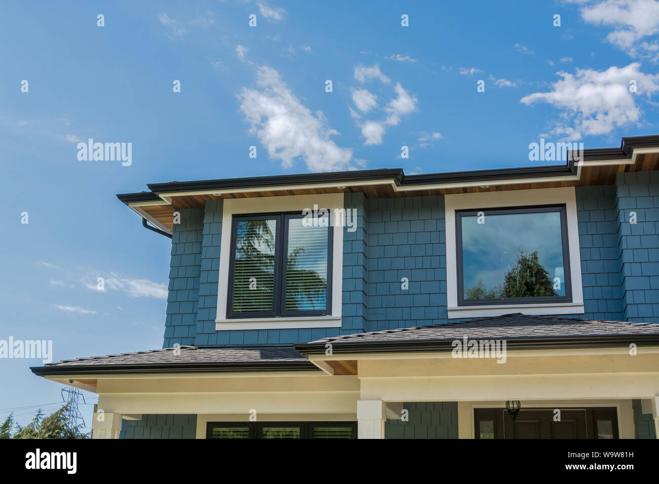 The top of the house with nice windows on cloudy sky background Stock ...