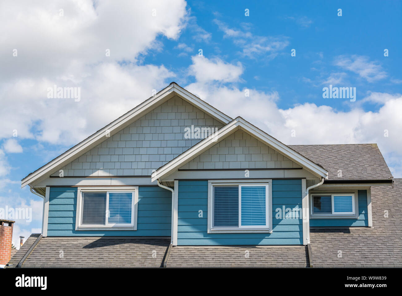 The top of the house with nice windows on cloudy sky background Stock ...