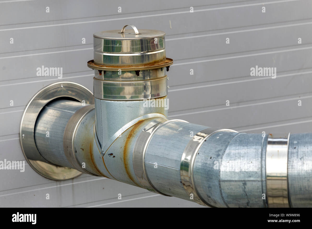 Metallic exhaust smoke pipes installed on house exterior wall Stock ...