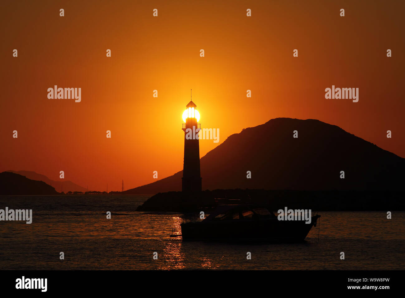 Seascape at sunset. Lighthouse on the coast Stock Photo - Alamy