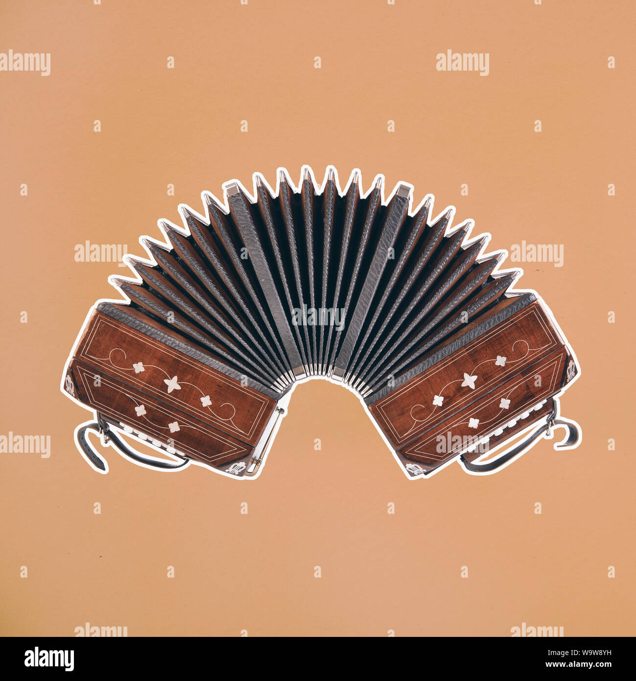 Bandoneon, tango instrument, with white border on square orange paper ...