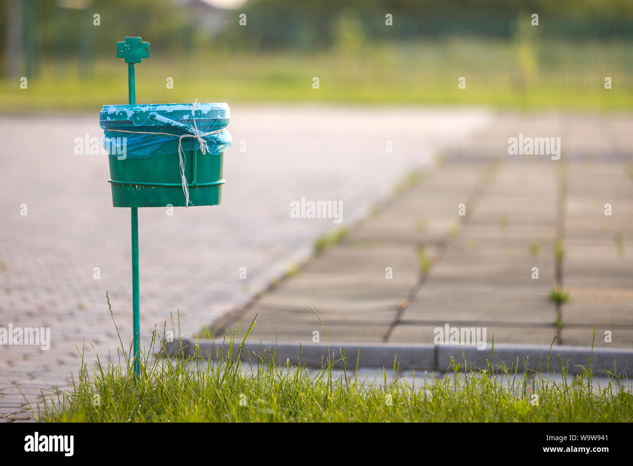 Garbage bin outdoor on blurred sunny background Stock Photo - Alamy