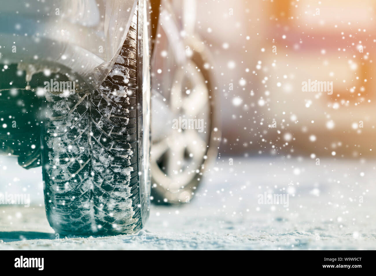 Close-up of car wheels rubber tires in deep winter snow. Transportation ...