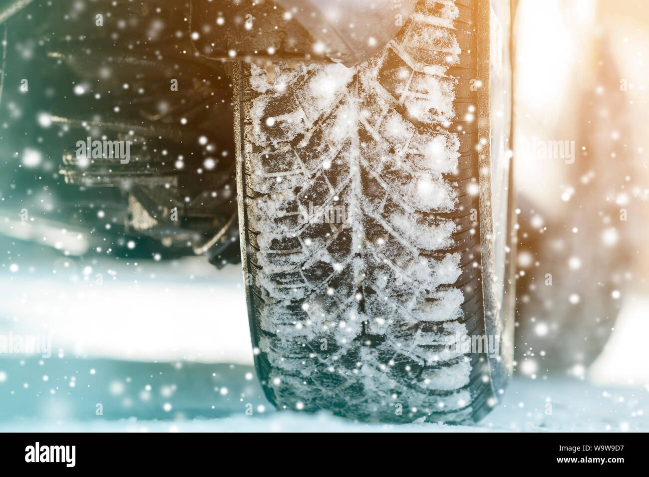 Close-up of car wheels rubber tires in deep winter snow. Transportation ...