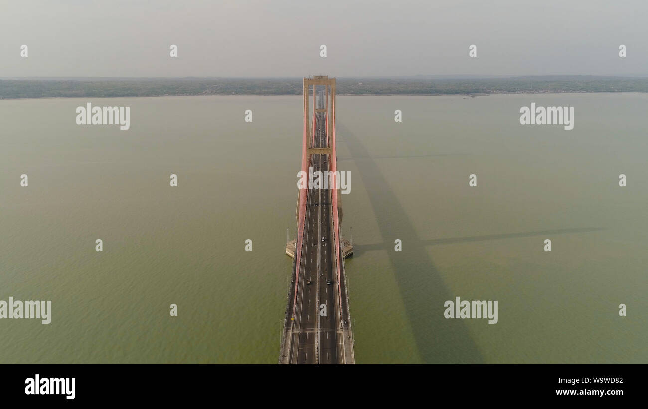 suspension bridge over madura strait with highway and car, surabaya ...