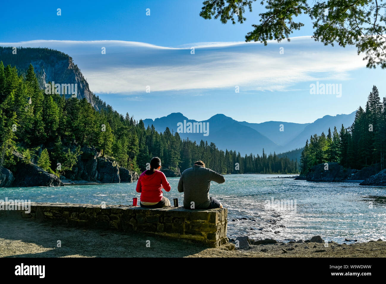 Couple enjoying view at Bow River, Banff National Park, Alberta, Canada ...