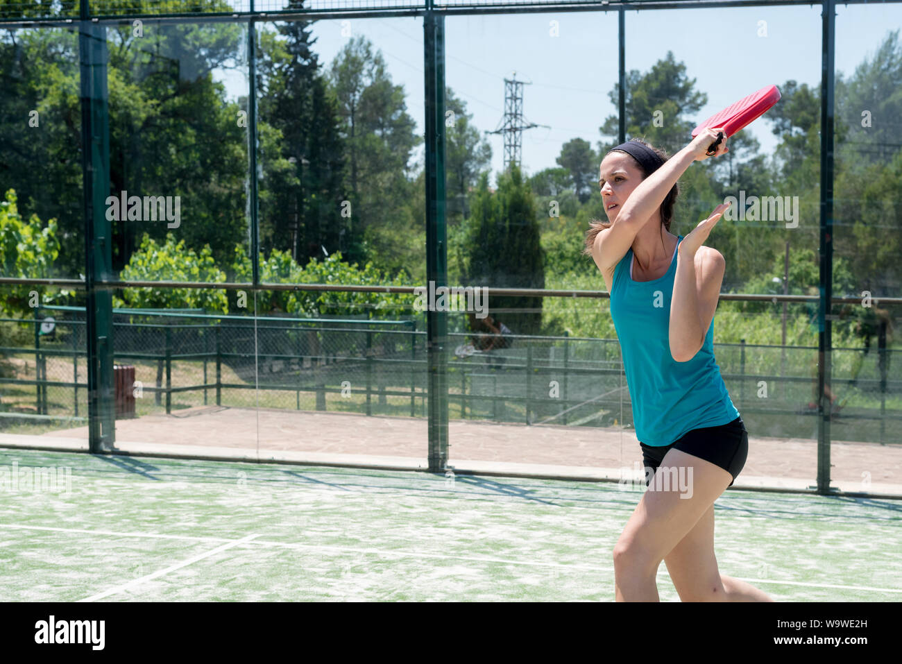 Young woman playing padel outdoor Stock Photo - Alamy