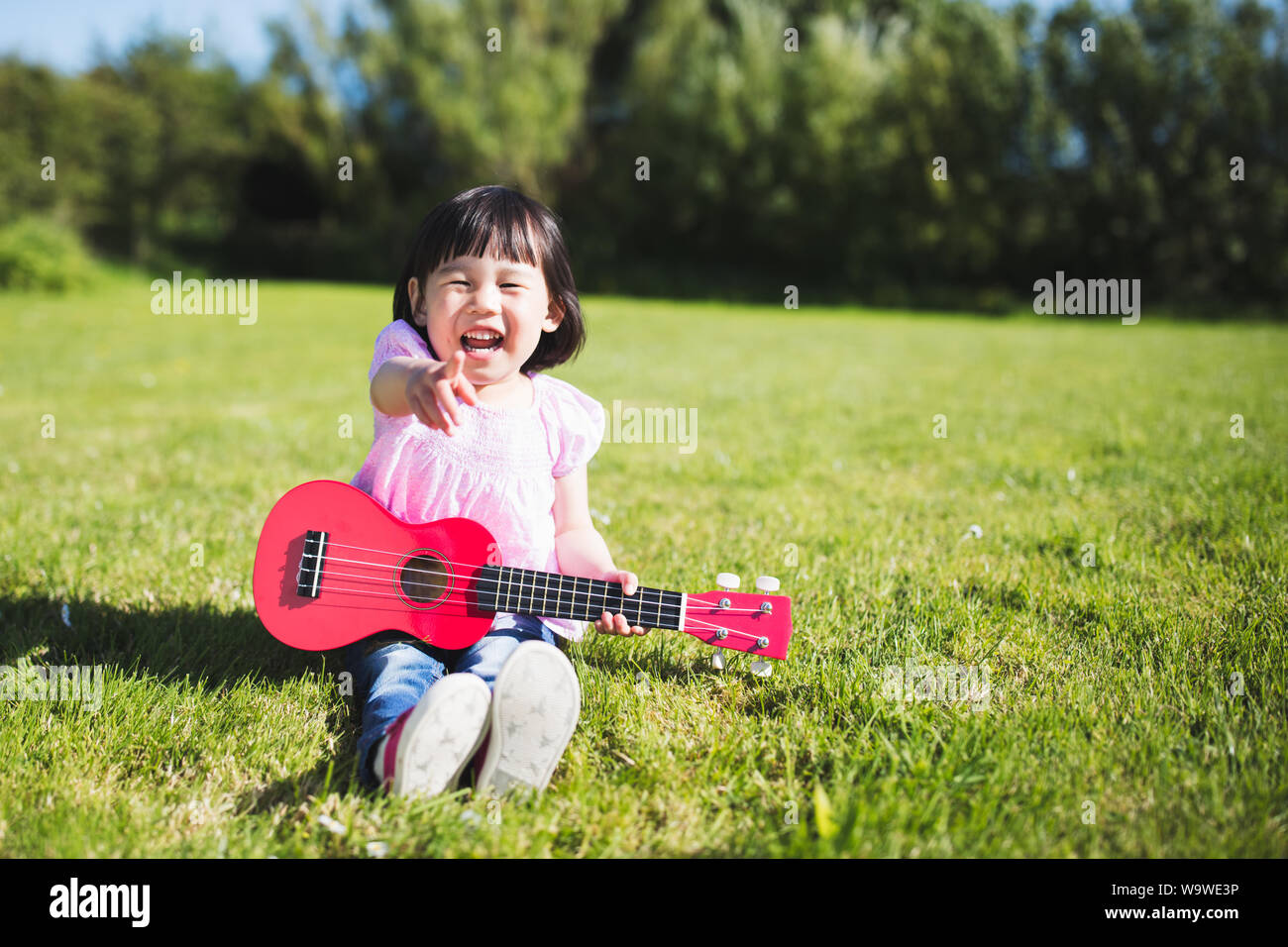 Chinese kids playing musical instrument hi-res stock photography and ...