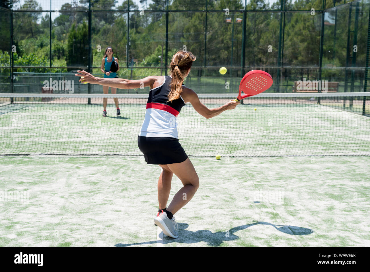 Two women playing padel outdoor Stock Photo - Alamy