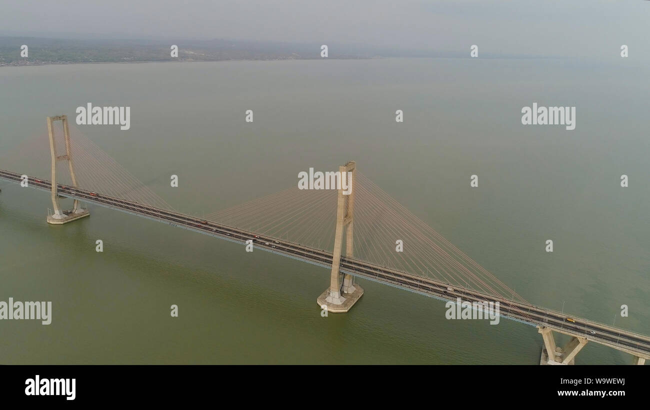 suspension bridge over madura strait with highway and car, surabaya ...